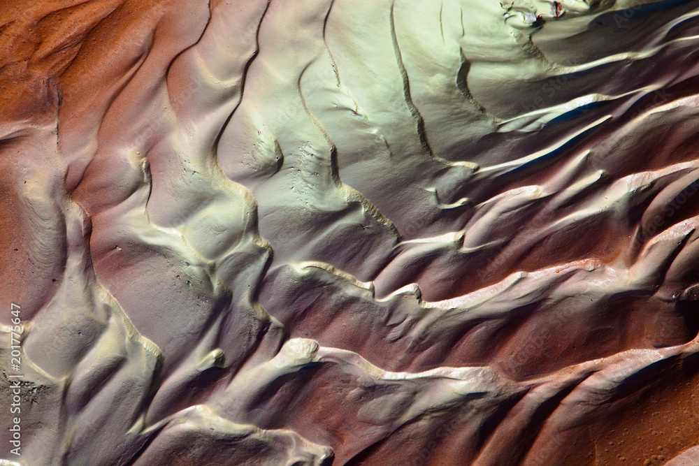 Wavy patterns in white and red mud made by run-off rainwater. Photo ...