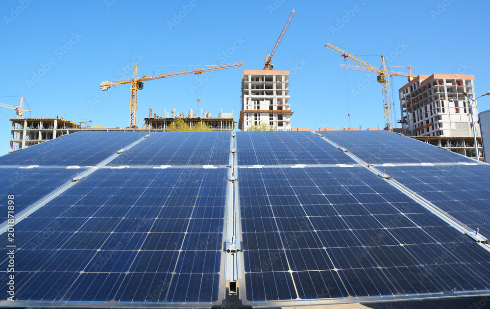 Green energy from solar cell harvesting sun light with cranes on the ...