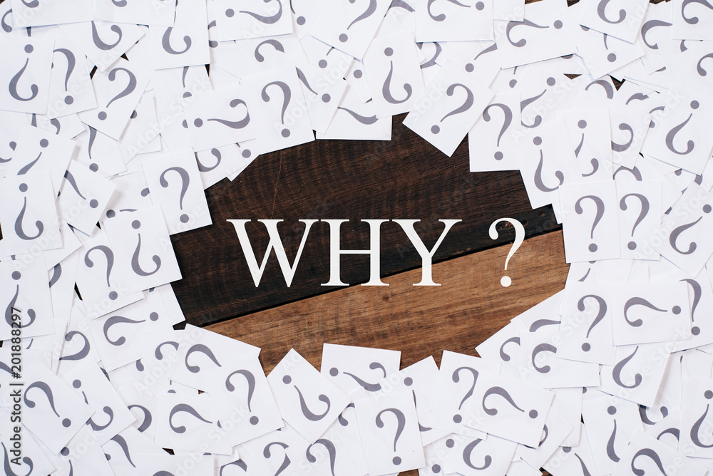 white paper note with question mark and WHY word in the center on ...