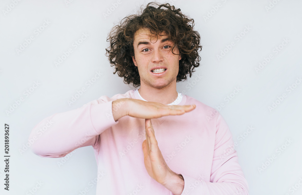 Horizontal portrait of serious male shows stop gesture, asks not to ...