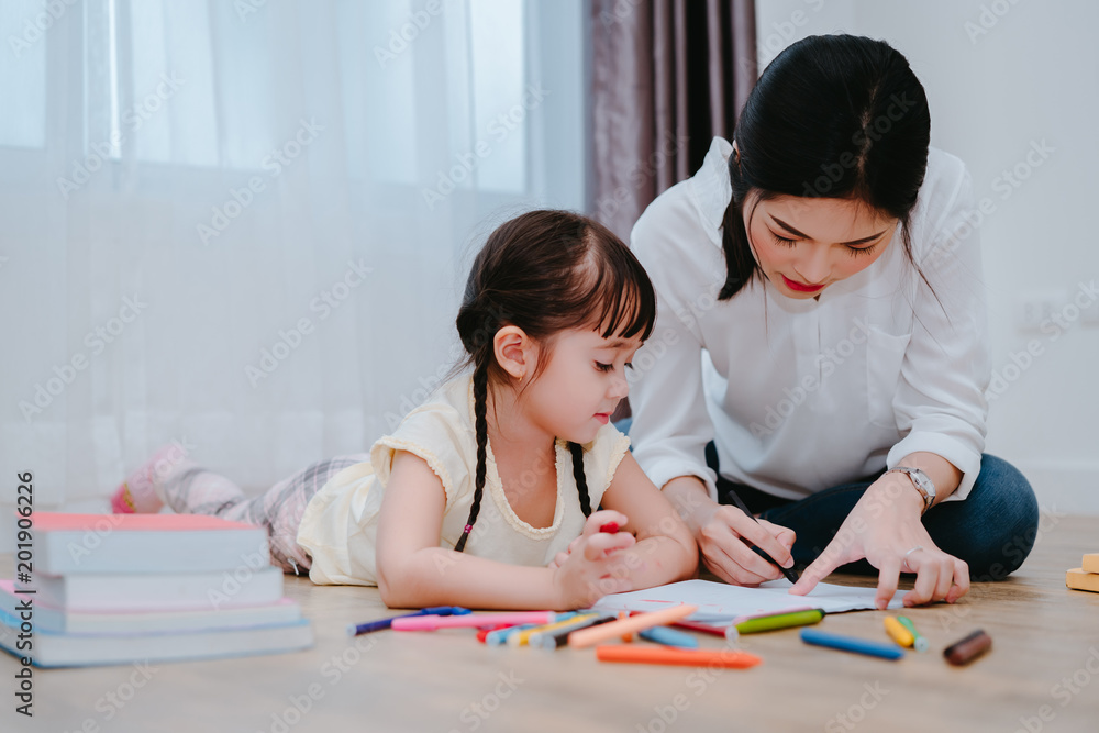 Mother and daughter study drawing with crayon paint on the paper family ...