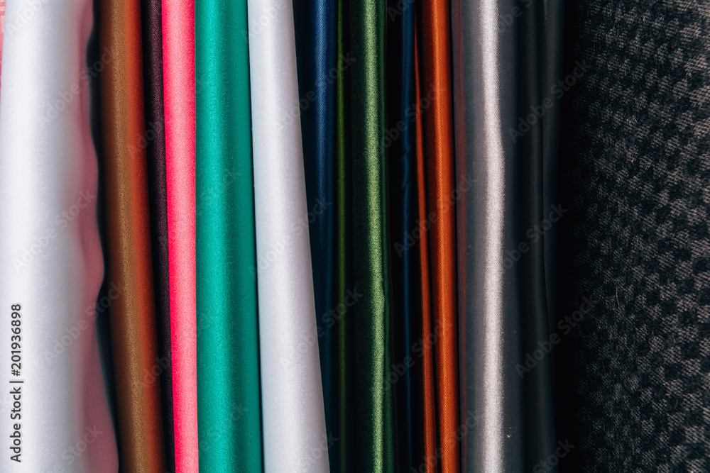 Different types of fabrics are stacked in a row Stock Photo | Adobe Stock