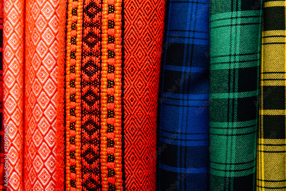 Different types of fabrics are stacked in a row Stock Photo | Adobe Stock