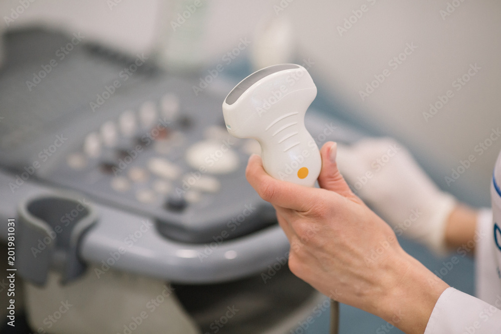 sonographer using ultrasound machine at work Stock Photo | Adobe Stock