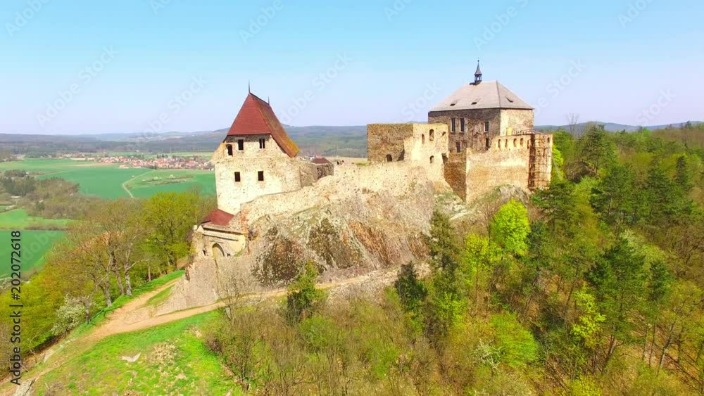 Drone flight around Tocnik Castle in blooming orchard. A royal chateau ...
