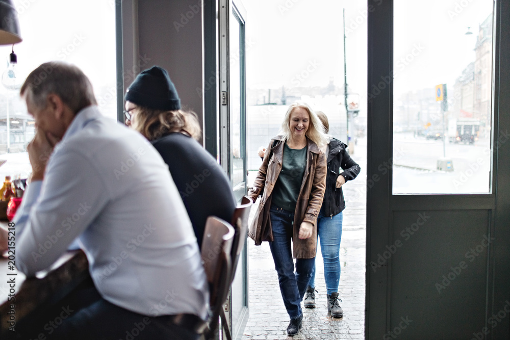 Customers entering restaurant Stock Photo | Adobe Stock