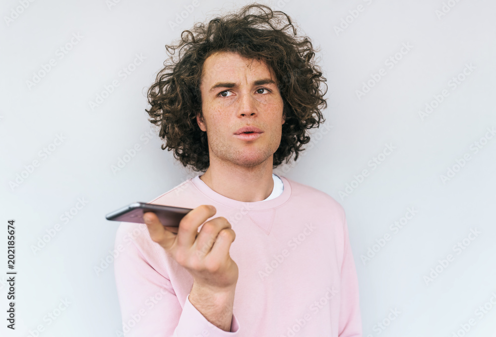 Handsome Caucasian male with curly hair has communication with friend ... Handsome Caucasian male with curly hair has communication with friend ...