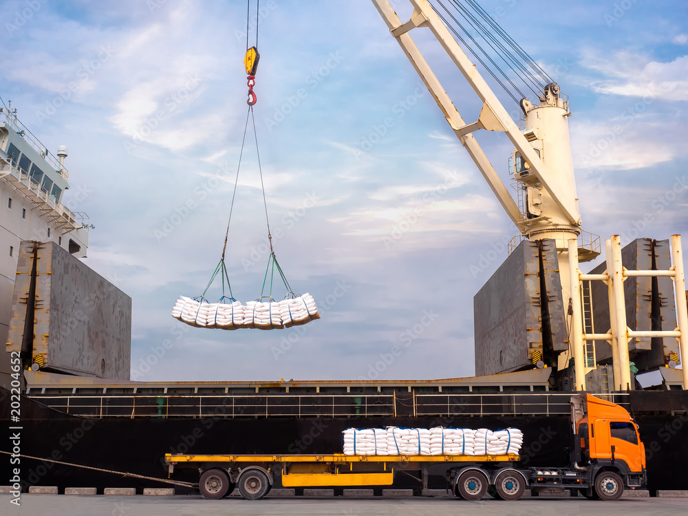 Sugar bags are loading in hold of bulk-vessel at industrial port,Pick ...