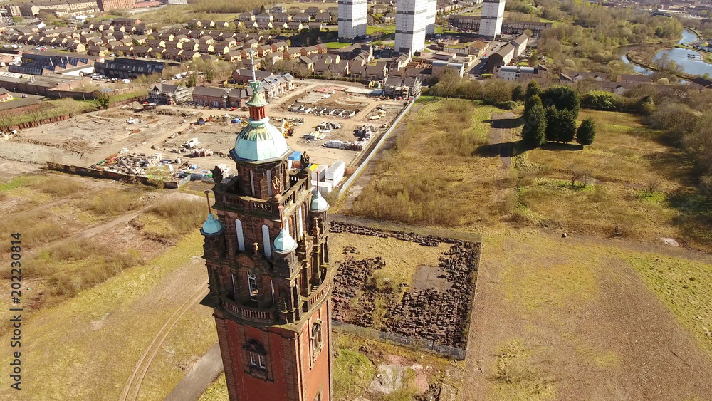 Aerial image of Ruchill Tower in Glasgow. A tall square red brick and ...