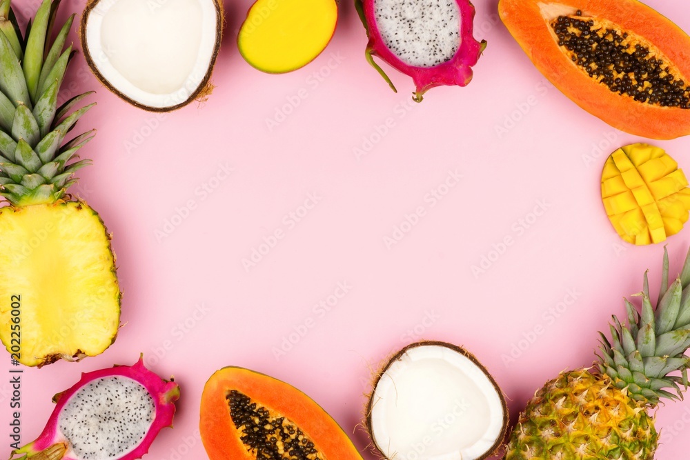 Tropical fruit frame with pineapple, dragon fruit, papaya, coconut and ...