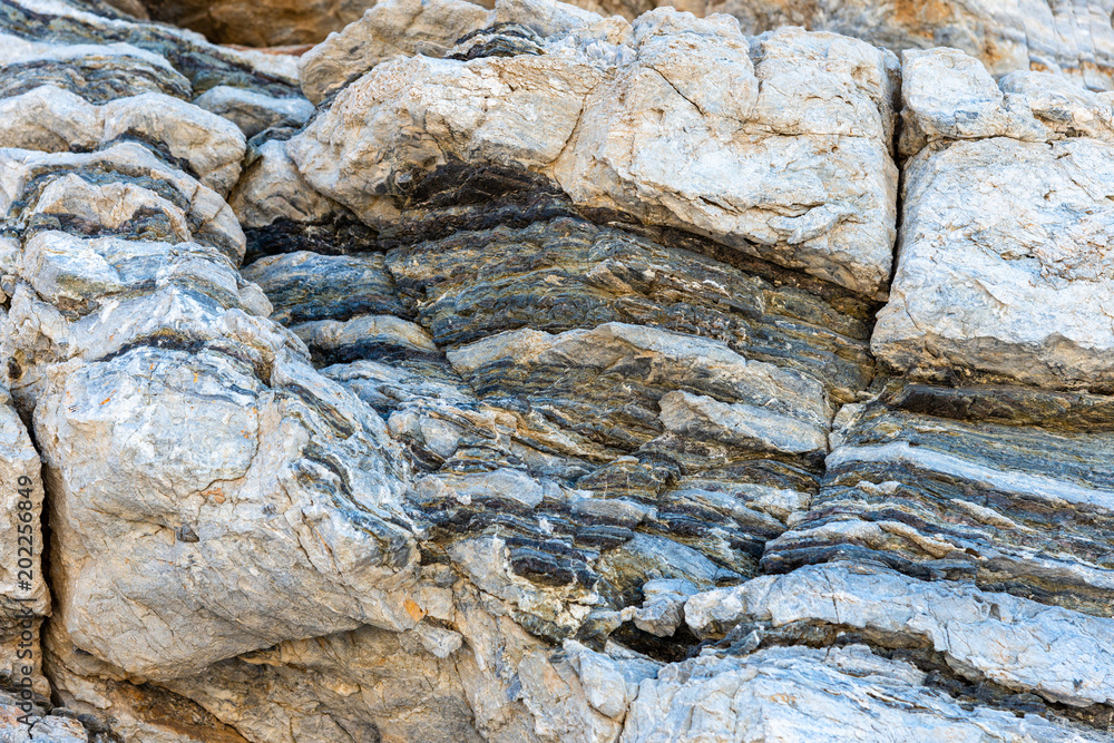 Compressed rock layers formation in various colors and thicknesses, on ...