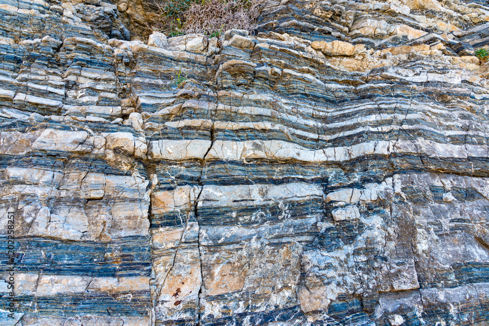 Compressed rock layers formation in various colors and thicknesses, on ...