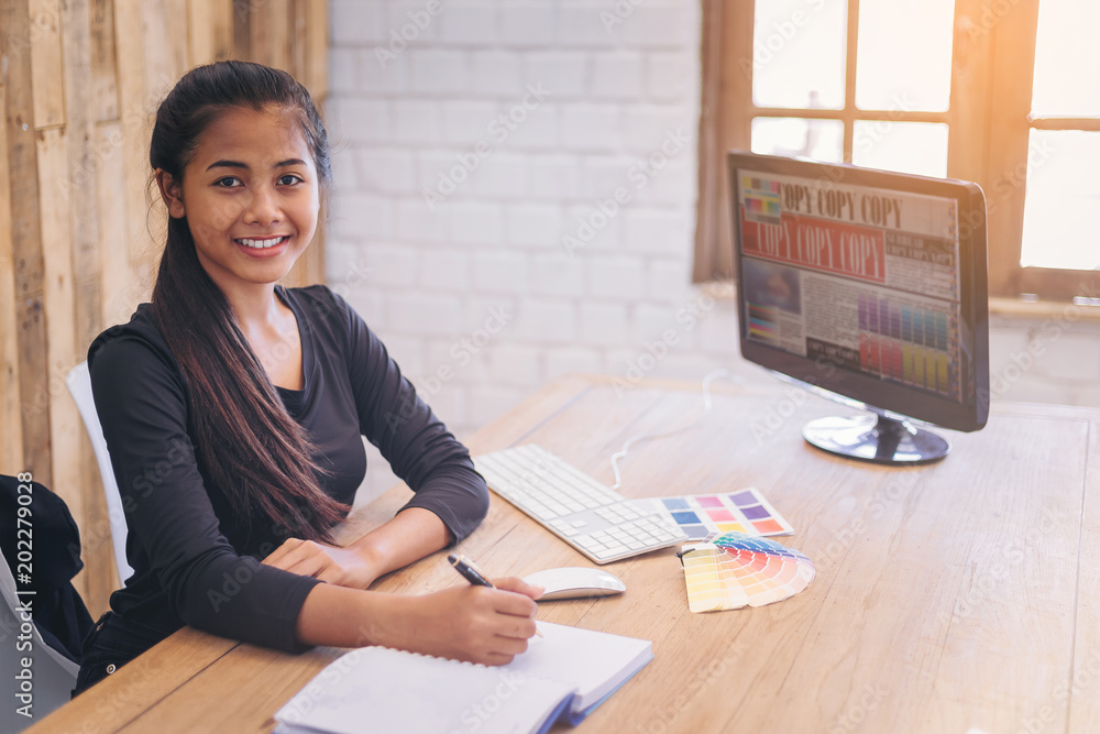woman designer working graphic on computer with color chart and imagine ...
