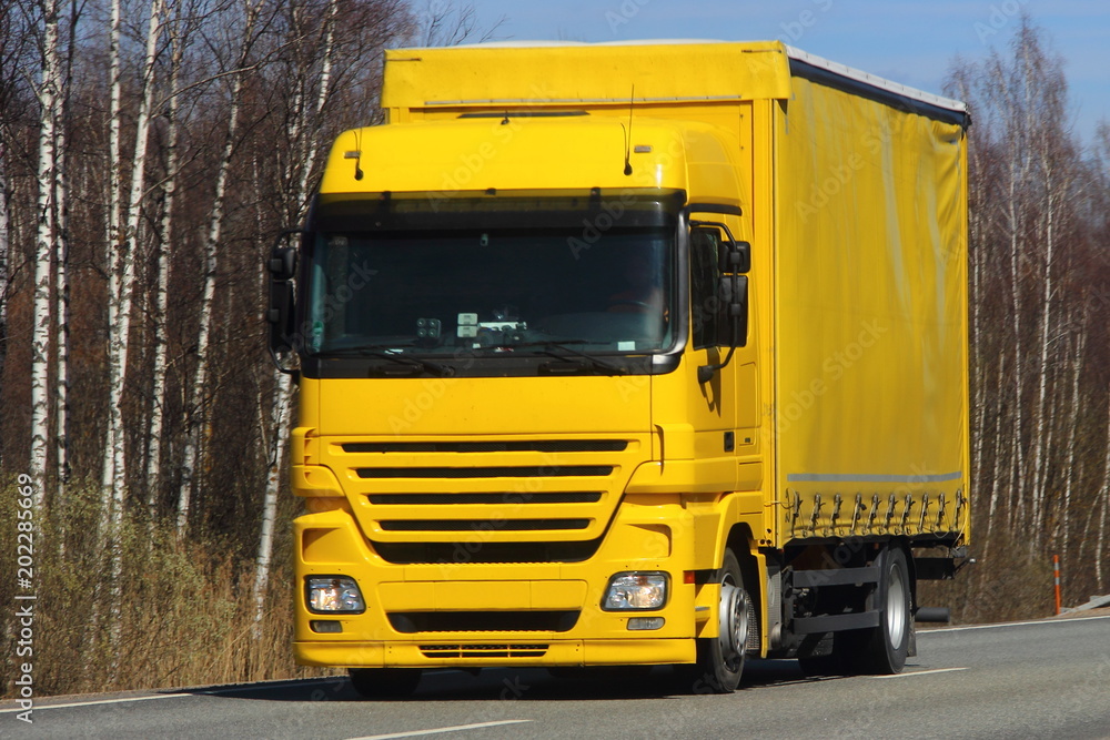 Transportation logistics - yellow truck with yellow semi-trailer on ...