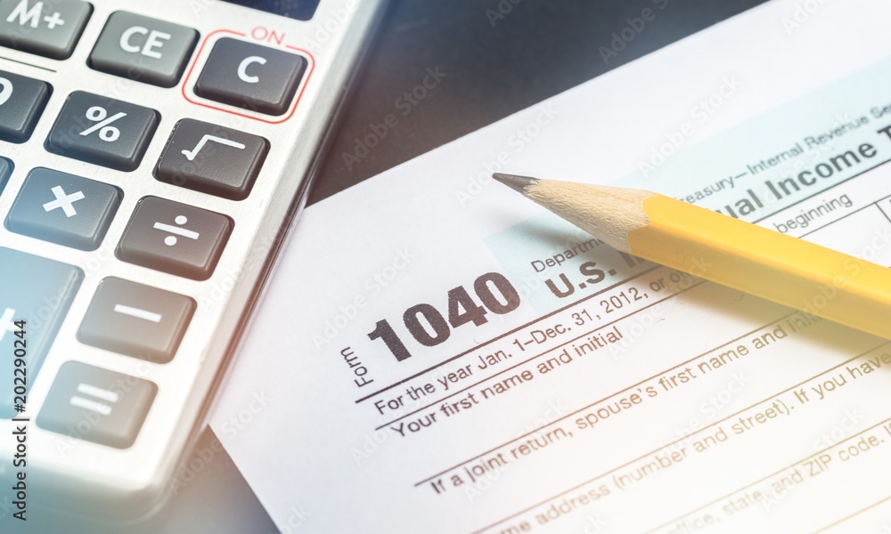 Tax form and calculator Stock Photo | Adobe Stock