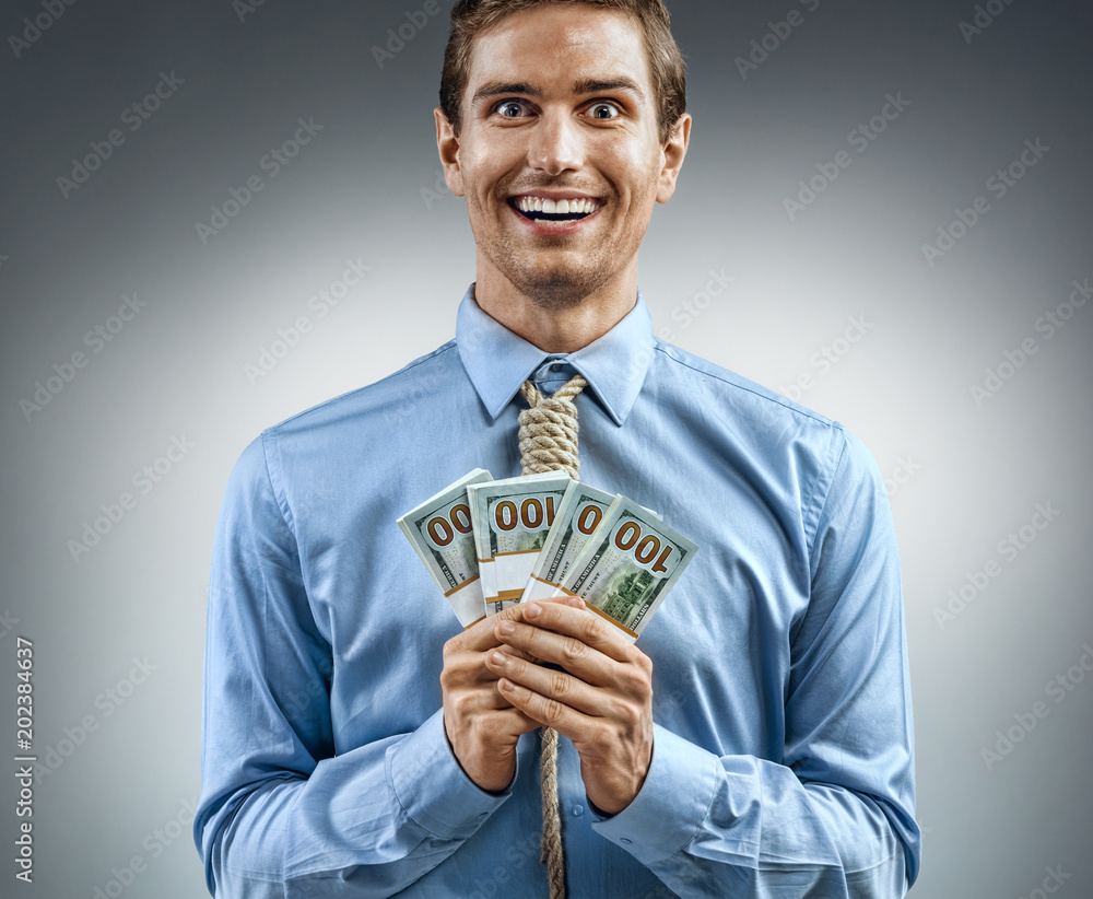 Happy man holding cash money. Photo of smiling man in blue shirt and ...