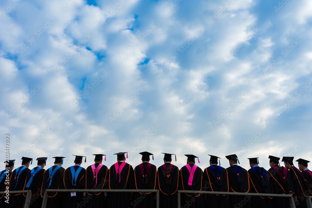 The graduates stand in line to take group photo in commencement ...