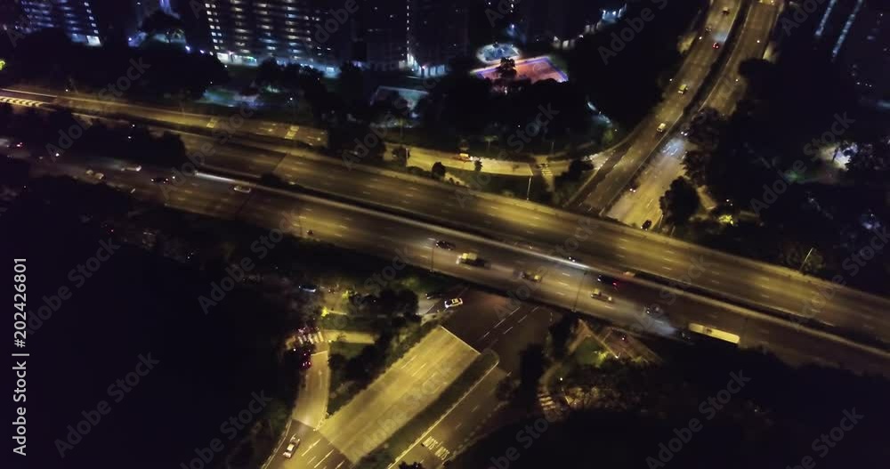Top down slow moving drone view of downtown city freeway interchange ...