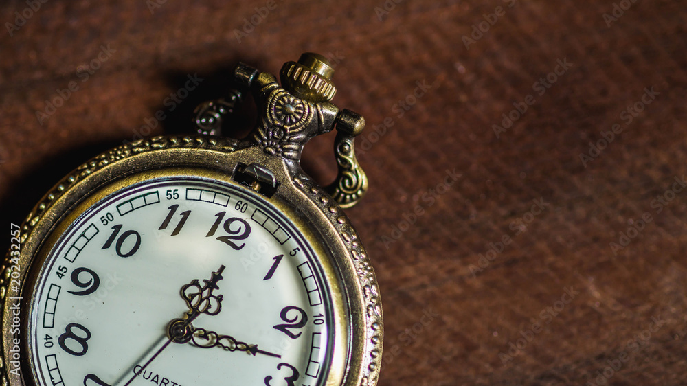 Old antique pocket watch showing time on blurred wooden background ...