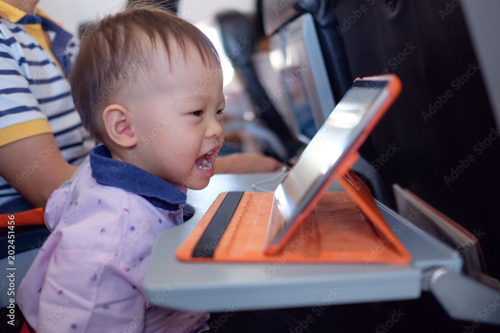 Cute little Asian 18 months / 1 year old toddler boy child using tablet ...