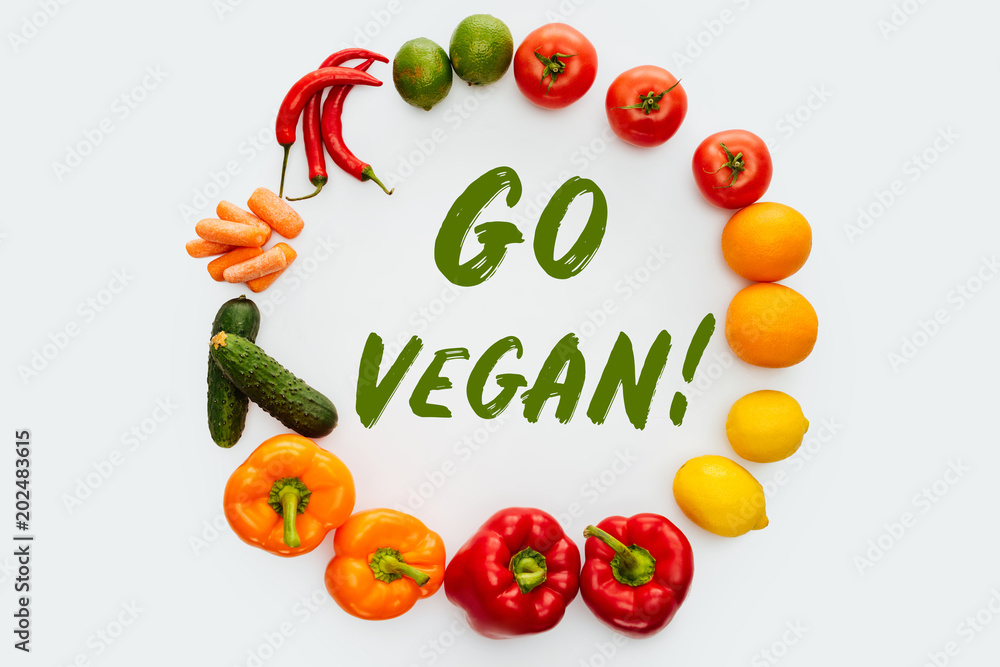 top view of circle of vegetables and fruits with text Go Vegan isolated ...