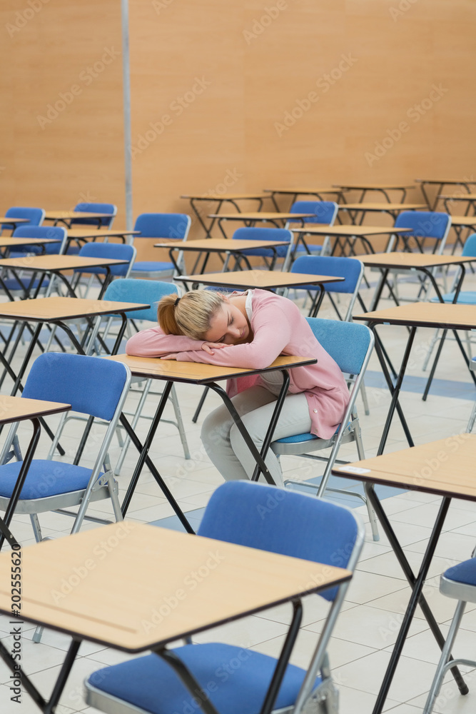 Student napping in exam hall Stock Photo | Adobe Stock