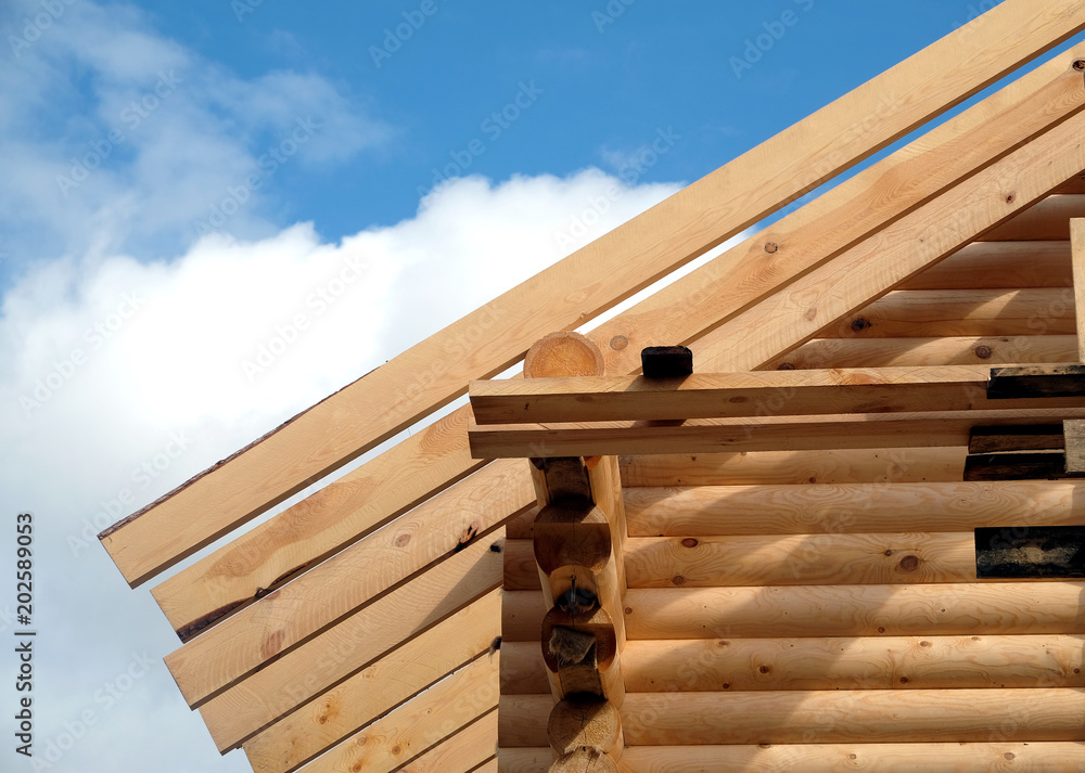 Process of wooden house straight roof slope mounting front view. Wooden ...