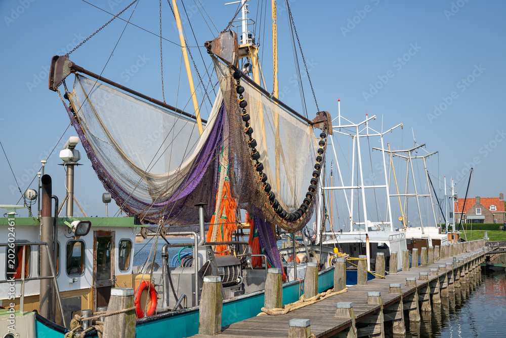Harbor dutch fishing village Makkum with shrimp trawler drying nets at ...