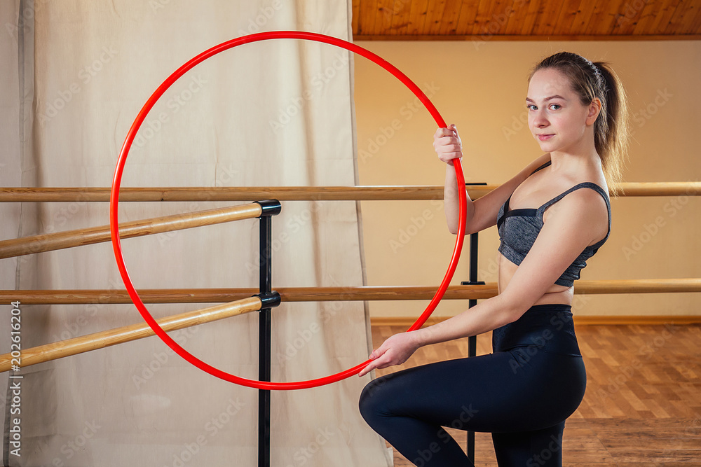 beautiful young girl doing sports with a red hoop Stock Photo | Adobe Stock