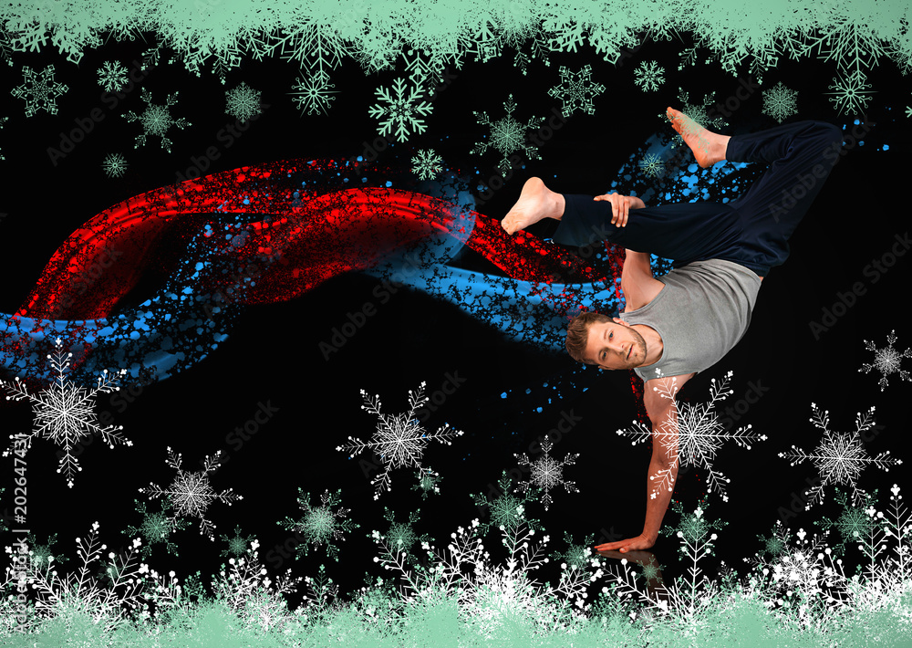 Break dancer showing his agility and balance against snow flake frame ...