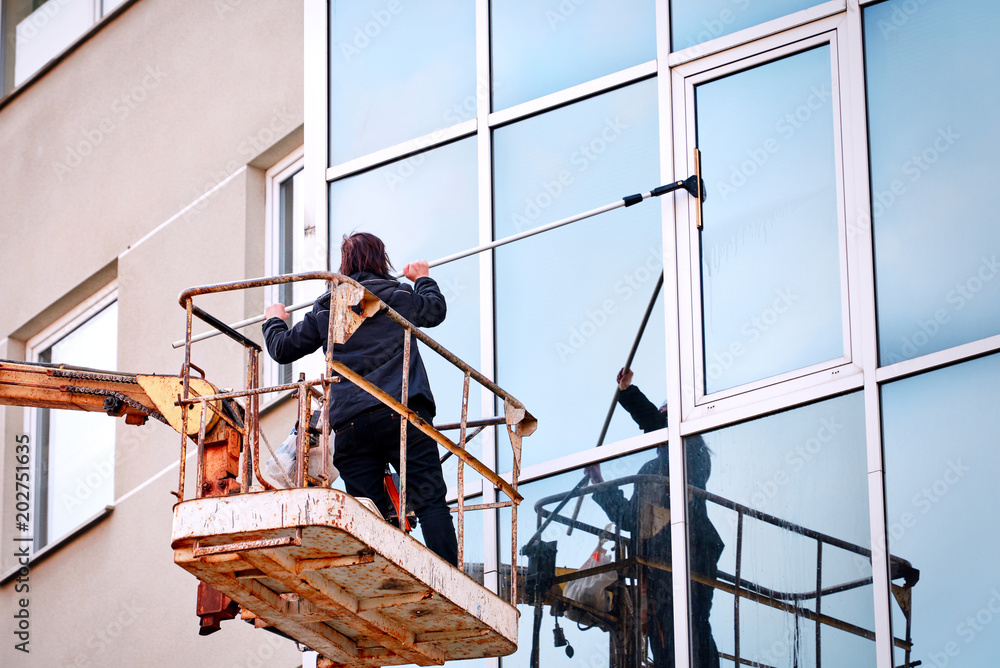 washing the glass facade at a height. Cleaning wall facade at height on ...