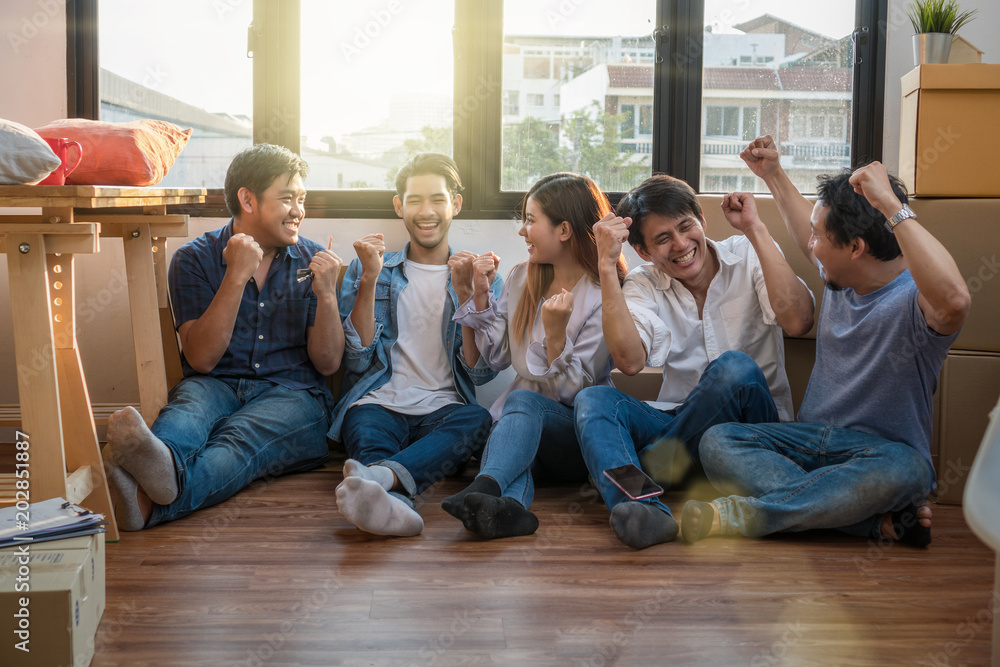 Group of Asian team work are glad after successfull packing the big ...