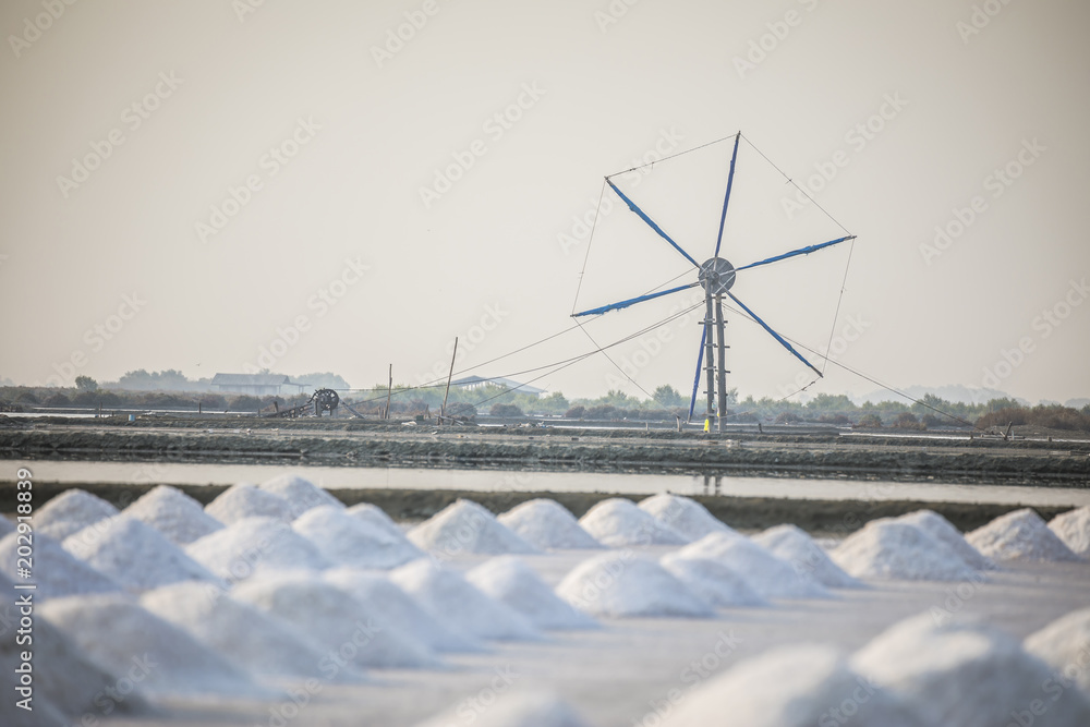 Salt piles in the Saline with Turbine from Samutsakorn, Thailand. Salt ...