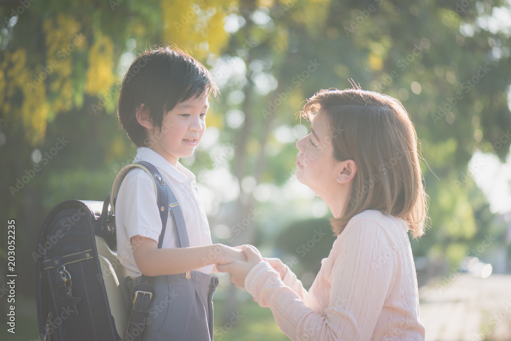 Asian mother saying goodbye to her son as he leave for School,back to ...