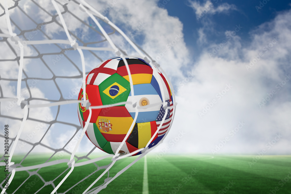 Football in multi national colours at back of net against football ...