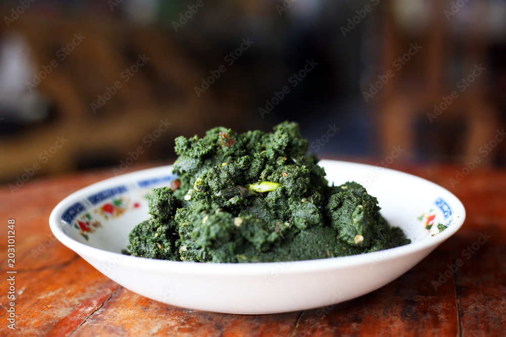 Fried swamp algae (Wolffia globosa) in white dish. Vegetarian food with ...