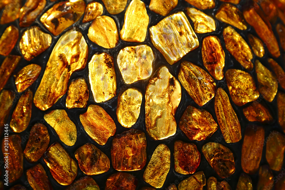 Luminous amber stones. Amber texture. Beautiful background from natural ...