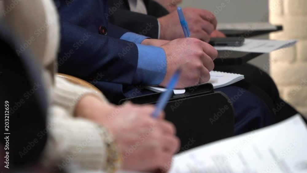 Video „A man in business suit write down information during conference ...