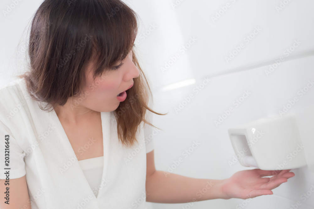 surprised woman with no toilet paper in restroom; portrait of asian ...