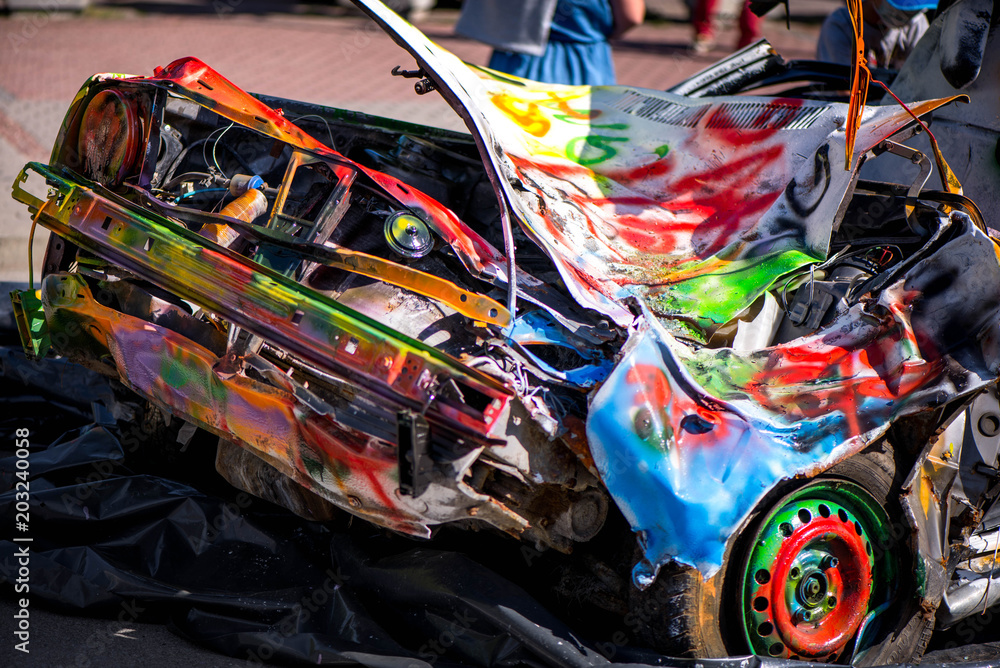 Macro shot of a colorfully painted car, an old crashed, damaged car ...