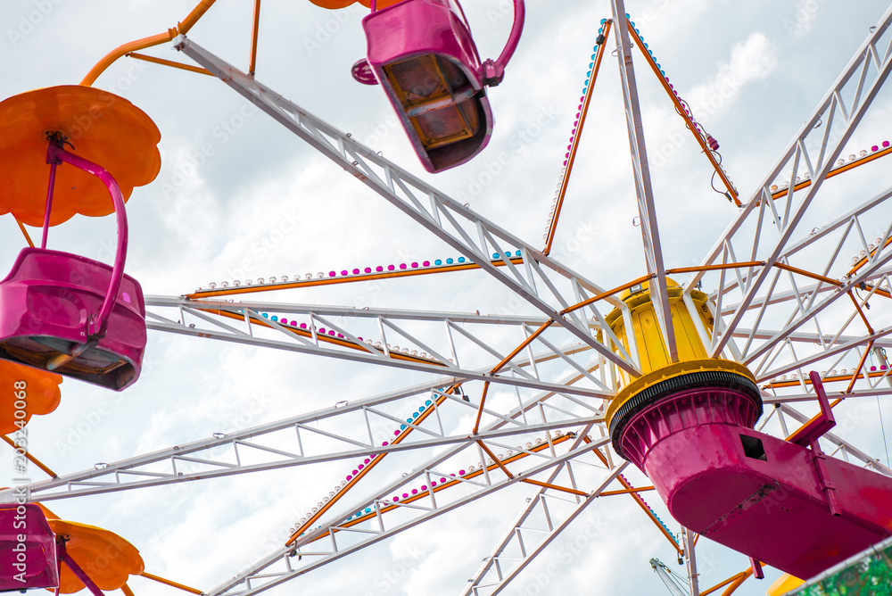 Colorful roller coaster seats at amusement park. People having fun in ...