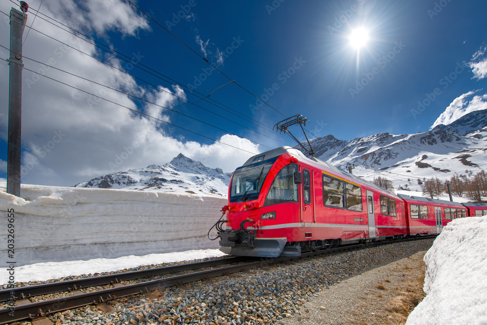 Swiss mountain train Bernina Express crossed Alps with snow wall Stock ...
