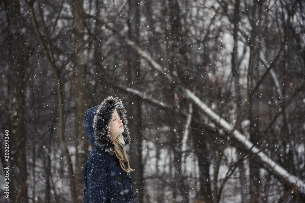 Side view of girl with eyes closed wearing warm clothing while standing ...