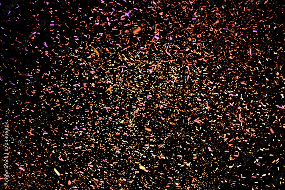 Confetti fired in the air during a beach party. Only confetti on black ...