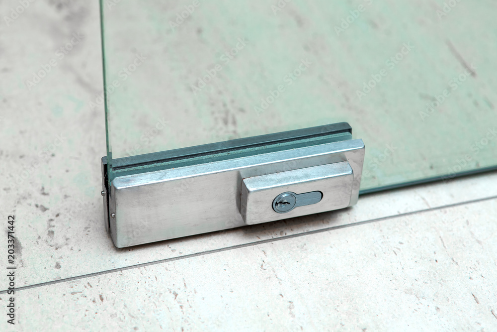 The lock on the glass door, the mechanism of locking the doors with the ...