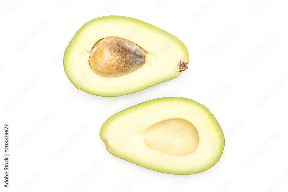Green smooth avocado one cut in two halves top view isolated on white ...