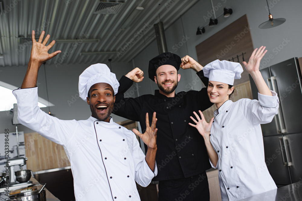 smiling multicultural chefs having fun at restaurant kitchen Stock ...