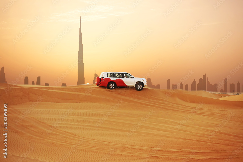 Off-road adventure with SUV in Arabian Desert at sunset with Dubai ...