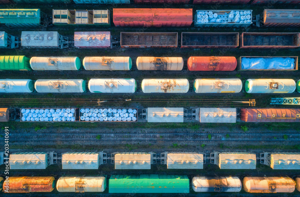 Aerial view of railway wagons. Cargo trains. Top view of colorful ...