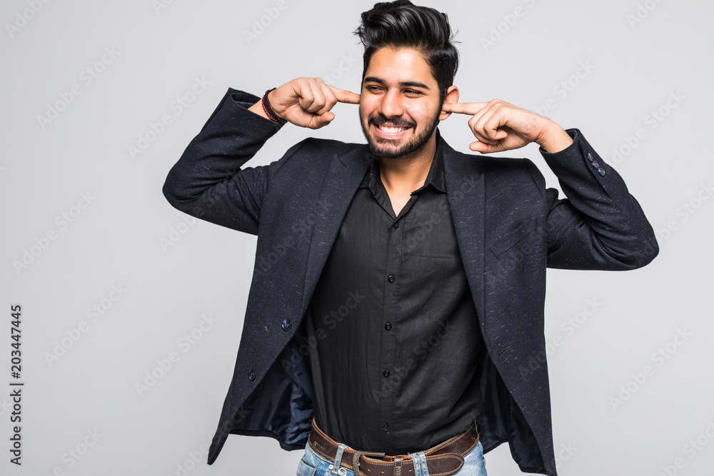 Handsome young indian man covered his ears by he is finger and ...